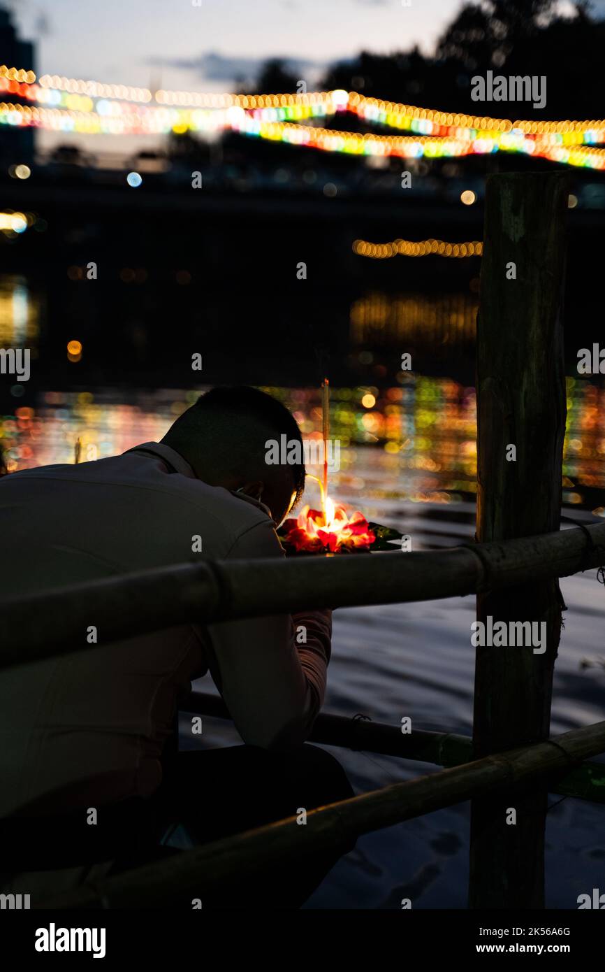 Man releasing a candle during Loy Krathong Festival in Chiang Mai ...
