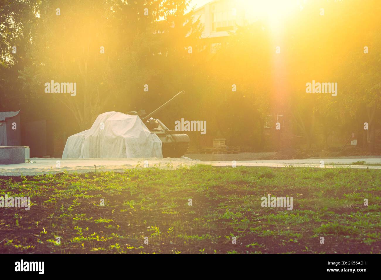 a tank covered with light material in the rays of evening backlight ...