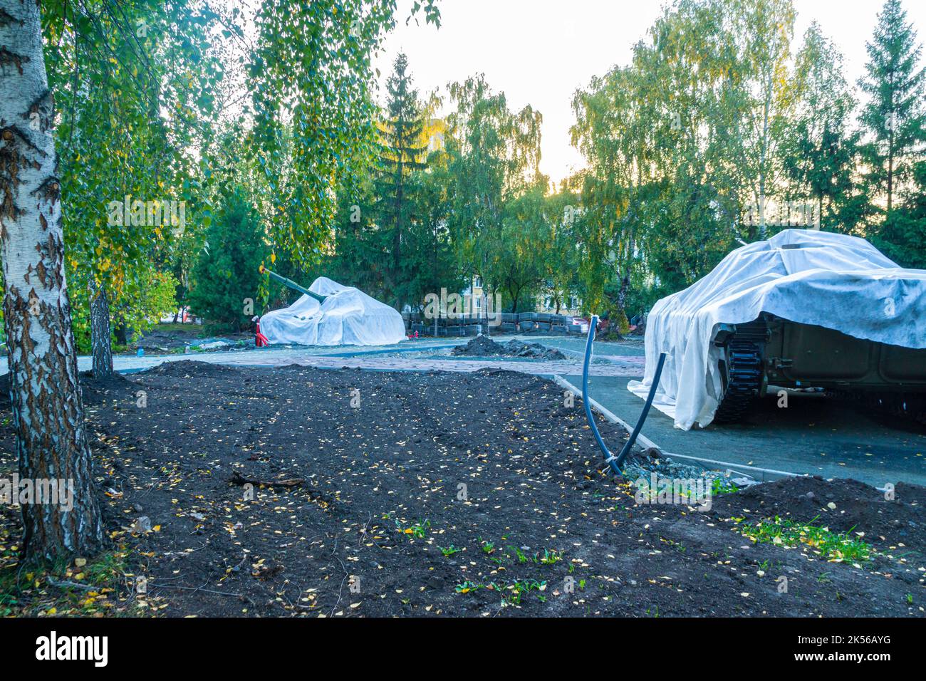 military tracked vehicles standing in the city square, covered with ...