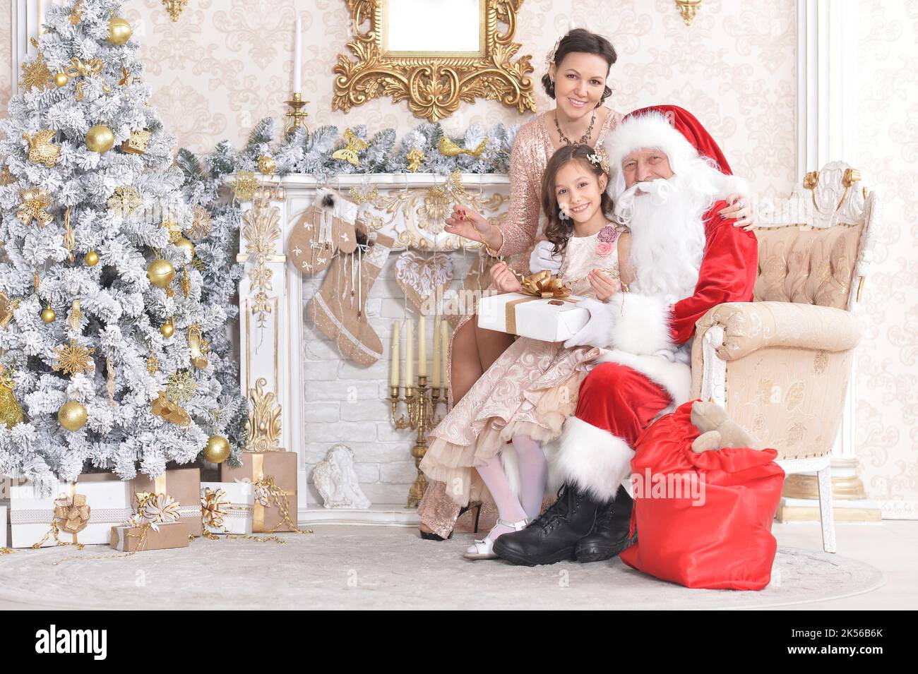 Santa Claus in a traditional costume with a girl in a room Stock Photo ...