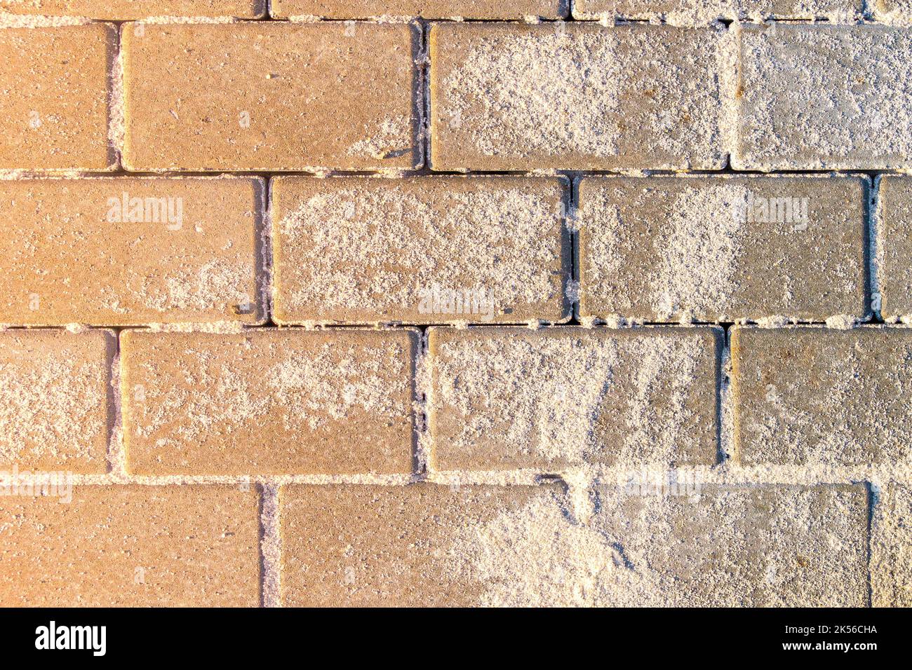 brown color gradient on the texture of paving slabs covered with sand ...