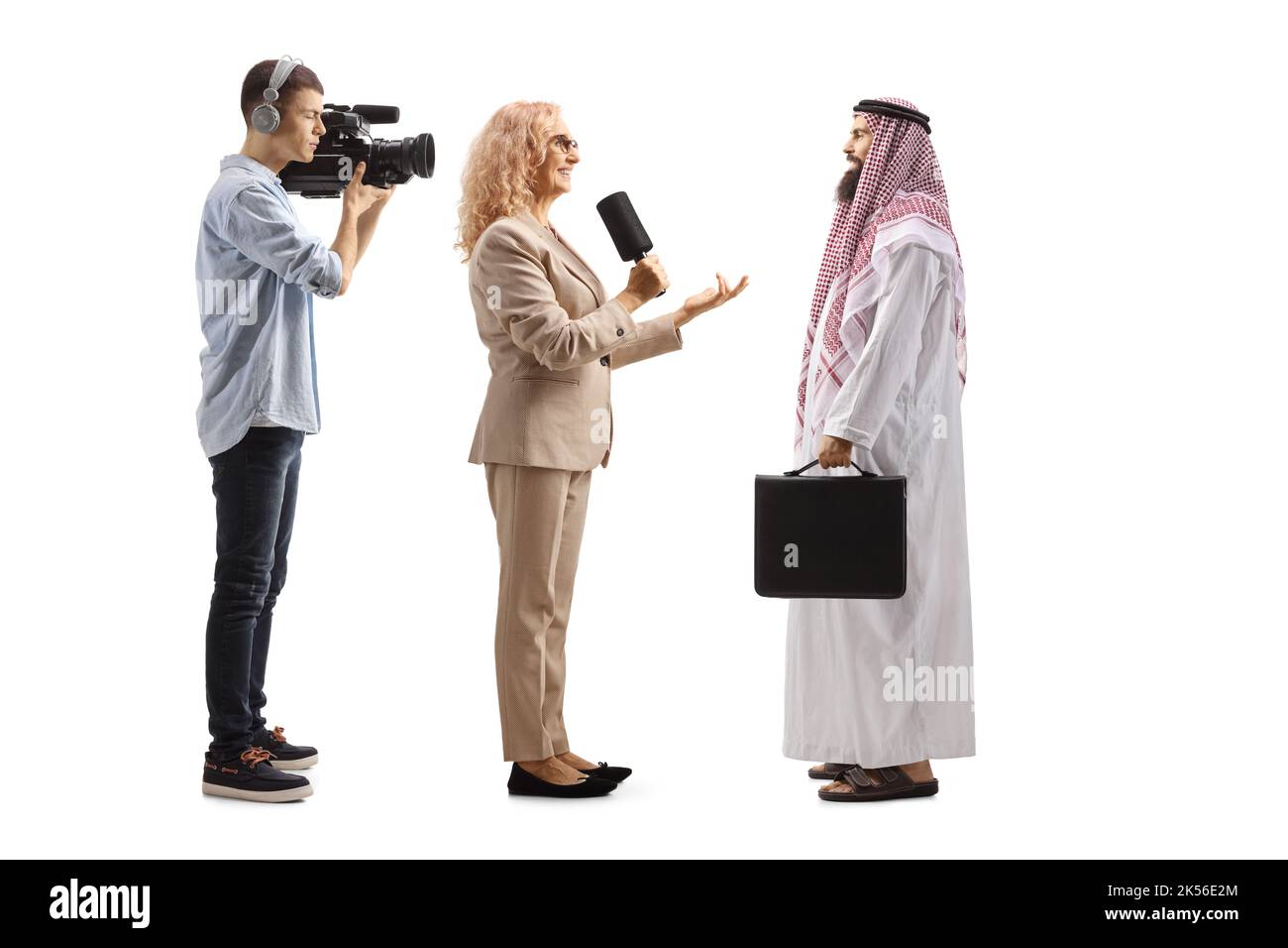 Female reporter interviewing a saudi arab man and camera man recording ...