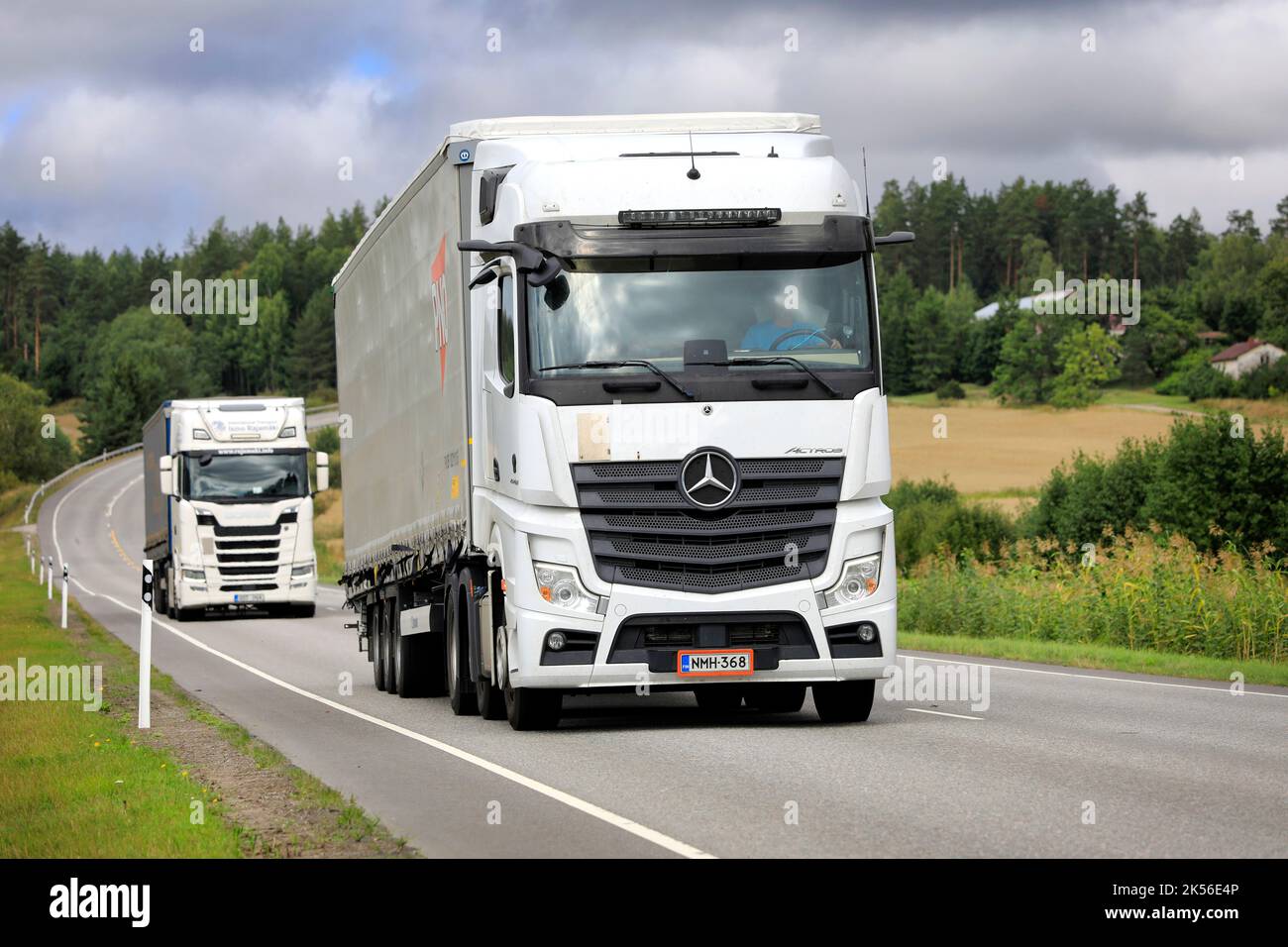 Two white heavy trucks, Mercedes-Benz Actros and Scania, pull semi ...