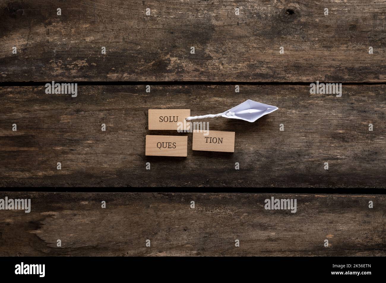 Conceptual image of problem solving - origami made paper boat pulling a ... Conceptual image of problem solving - origami made paper boat pulling a ...