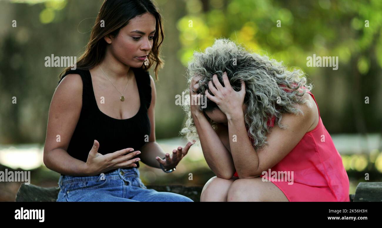 Friend consoling depressed desperate woman outside Stock Photo - Alamy