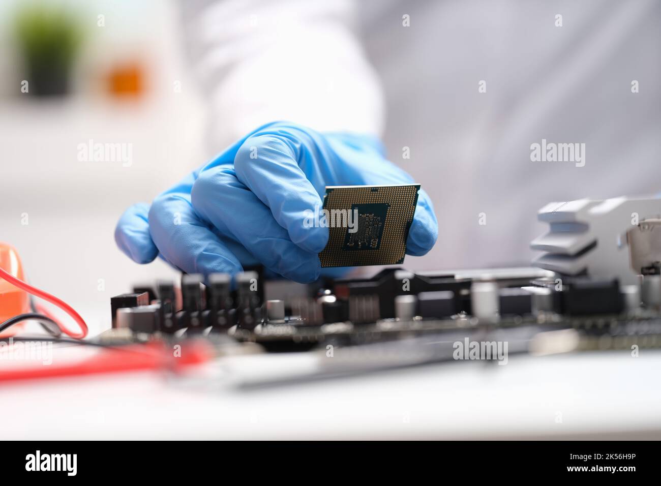 Technician connects a CPU microprocessor to motherboard socket Stock Photo - Alamy
