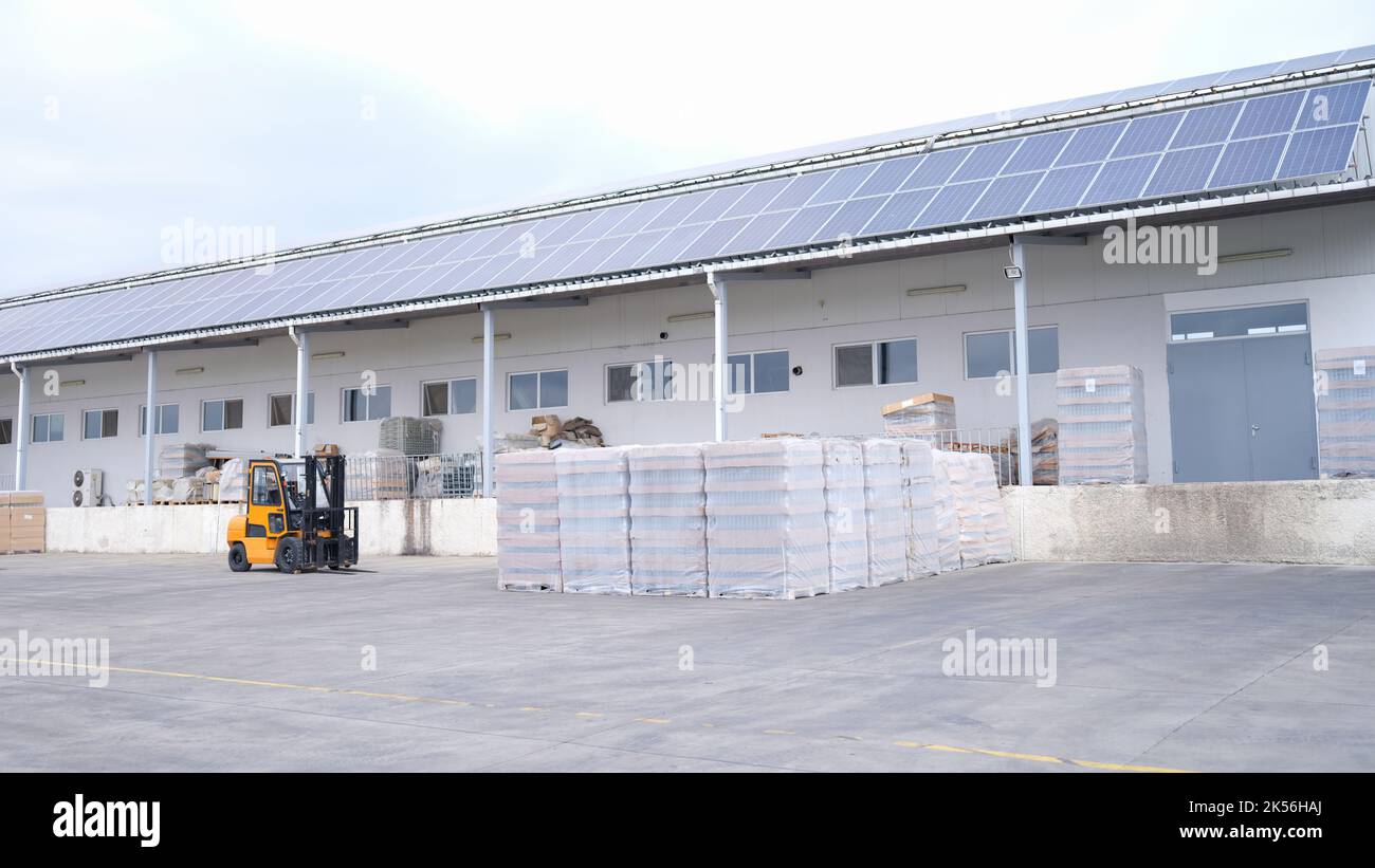 Forklift and pallets with goods in large warehouse outside warehouse ...