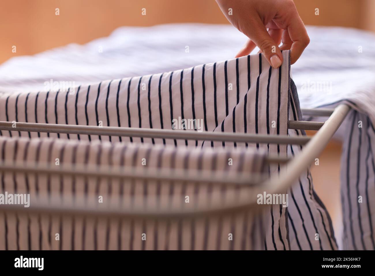 Woman hangs clean linen on clothes dryer after washing closeup Stock ...