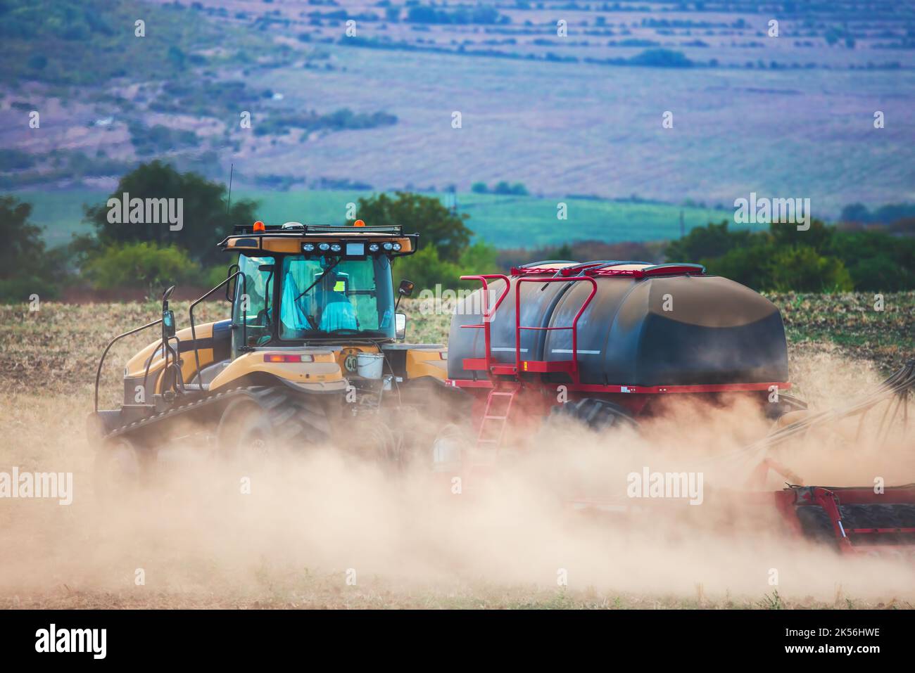 Farmer in tractor preparing land with seedbed cultivator Stock Photo ...