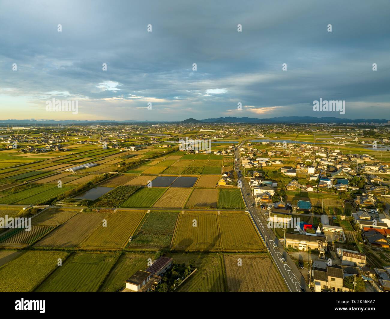 Aerial view of fields and farmland after harvest on edge of small town ...