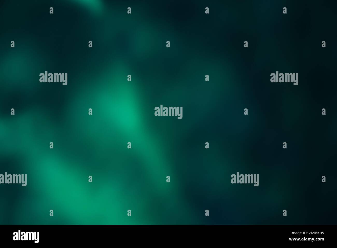 defocused glow color light flare green flecks dark Stock Photo - Alamy
