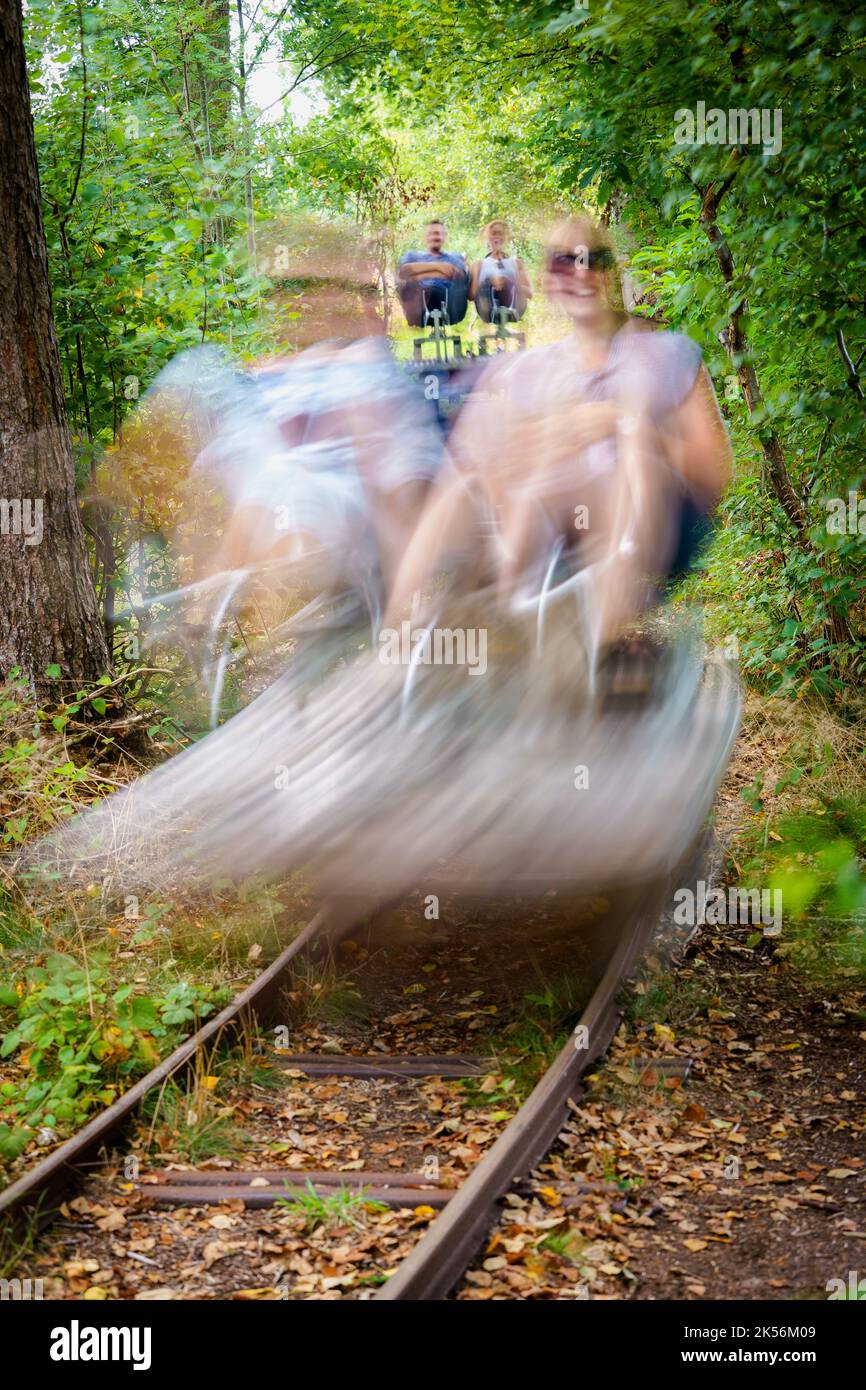 Family enjoying the rail bike attraction and having fun in the ...