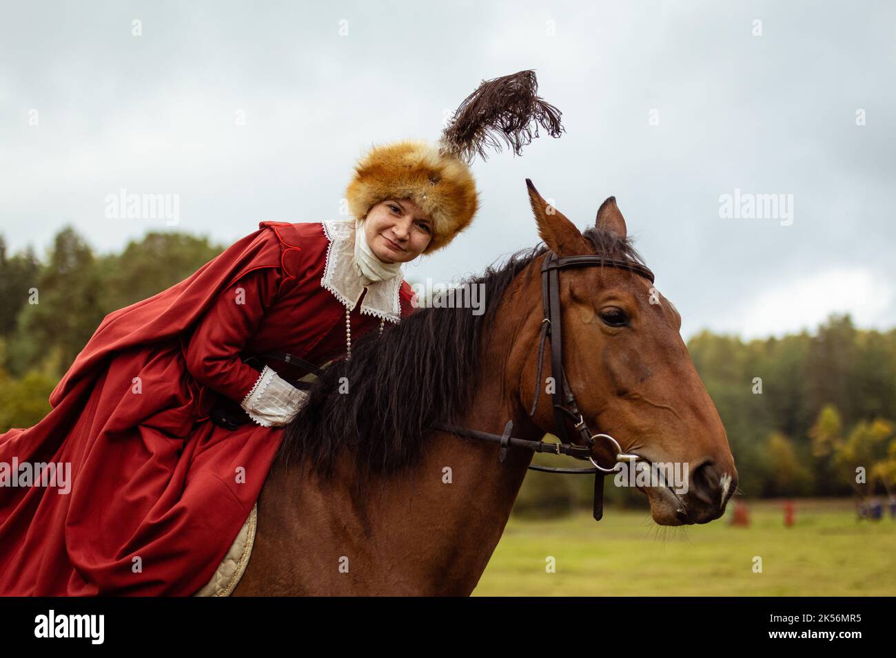Portrait of a female equestrian i on horseback. The woman is dressed in ...