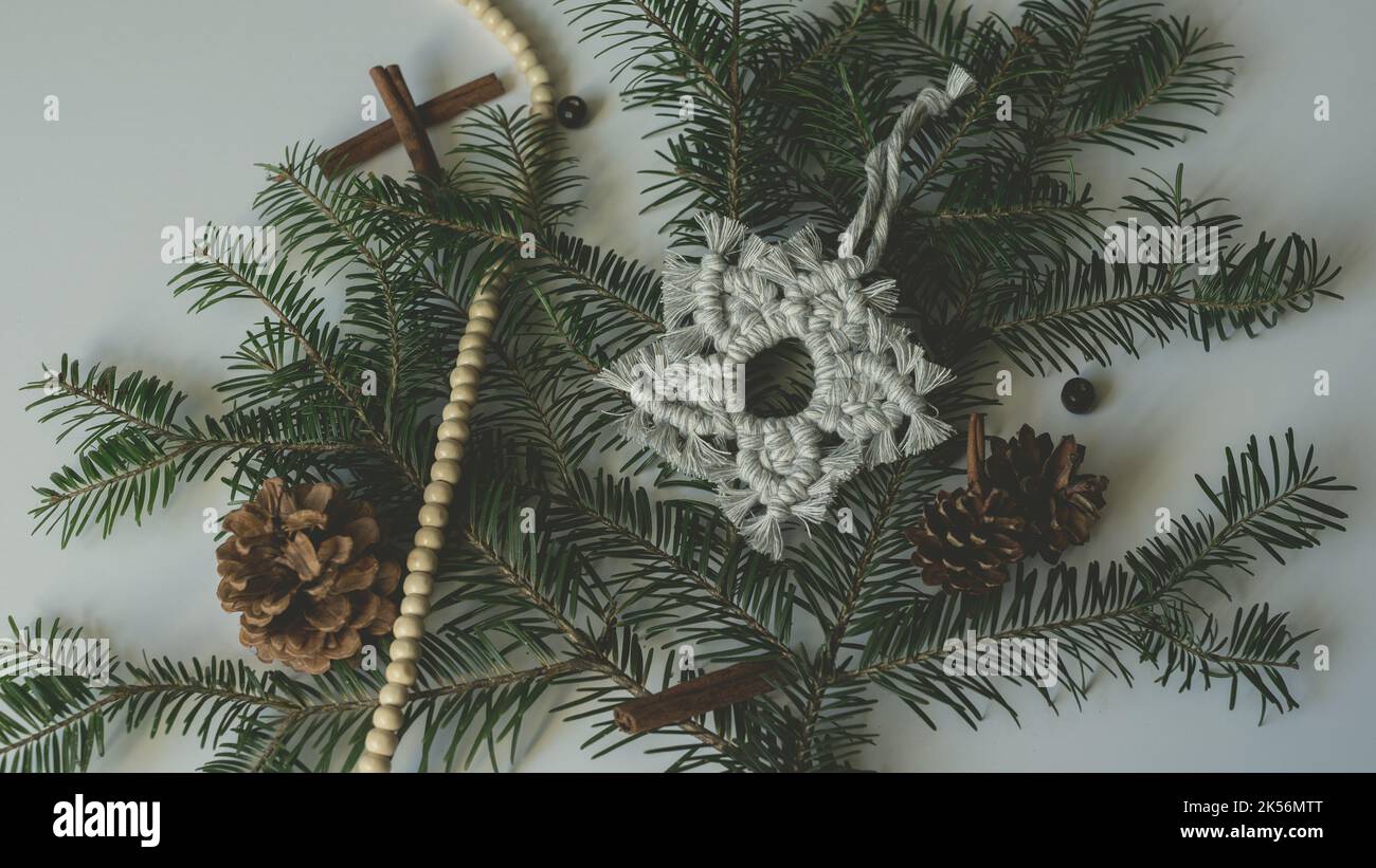 macramé snowflake Christmas holiday decoration on tree branches with ...