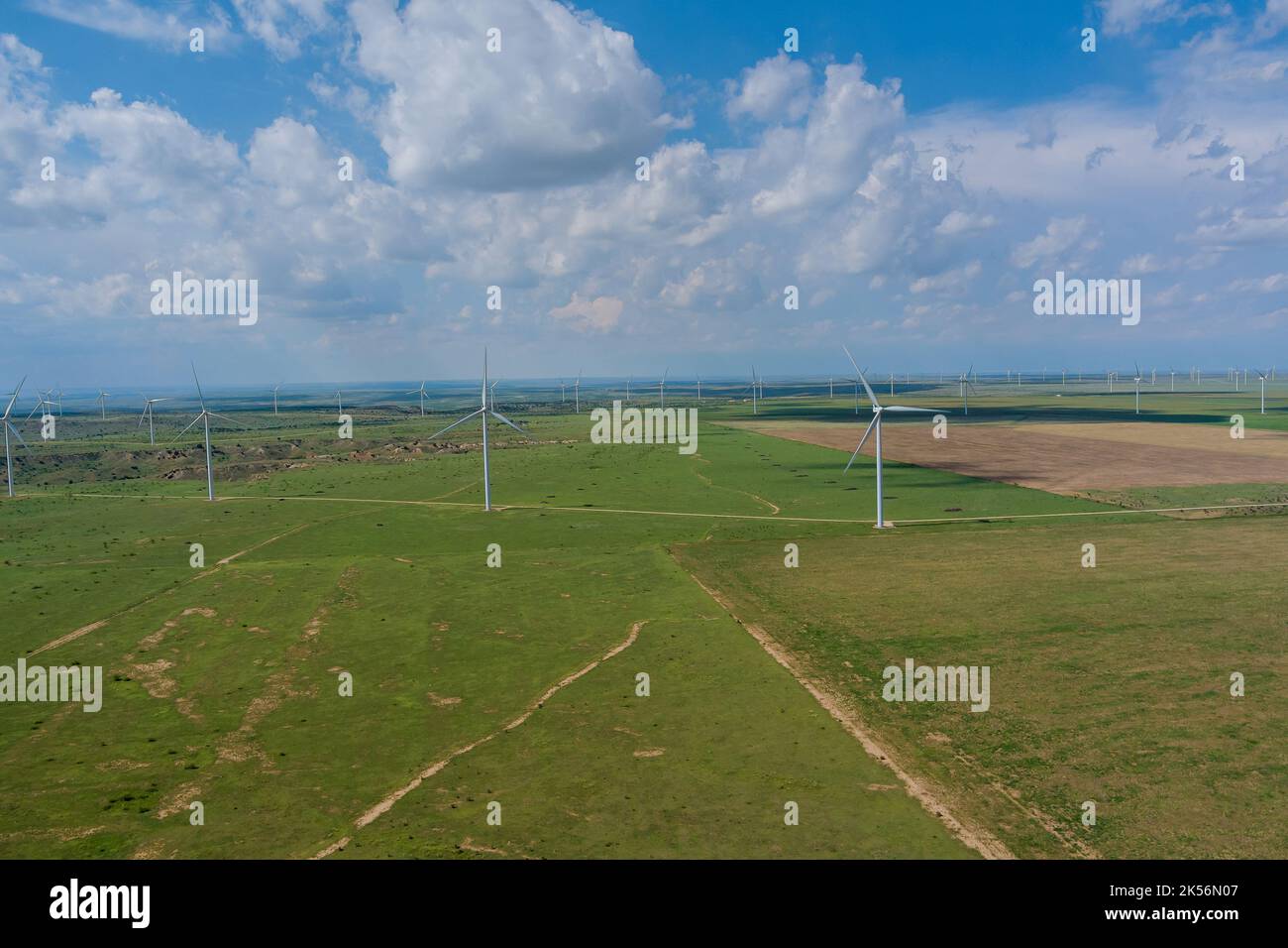A row of windmill renewable energy turbines on a wind farm in the Texas ...