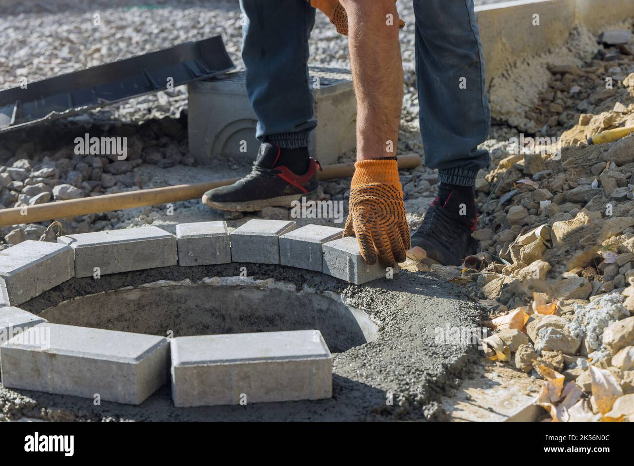 Worker constructing a pit for a septic tank sewer manhole ...