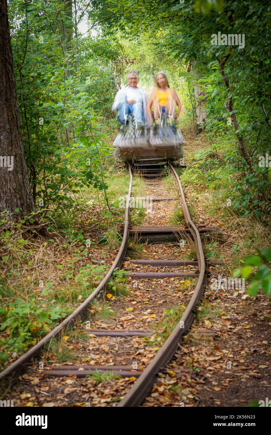 Family enjoying the rail bike attraction and having fun in the ...