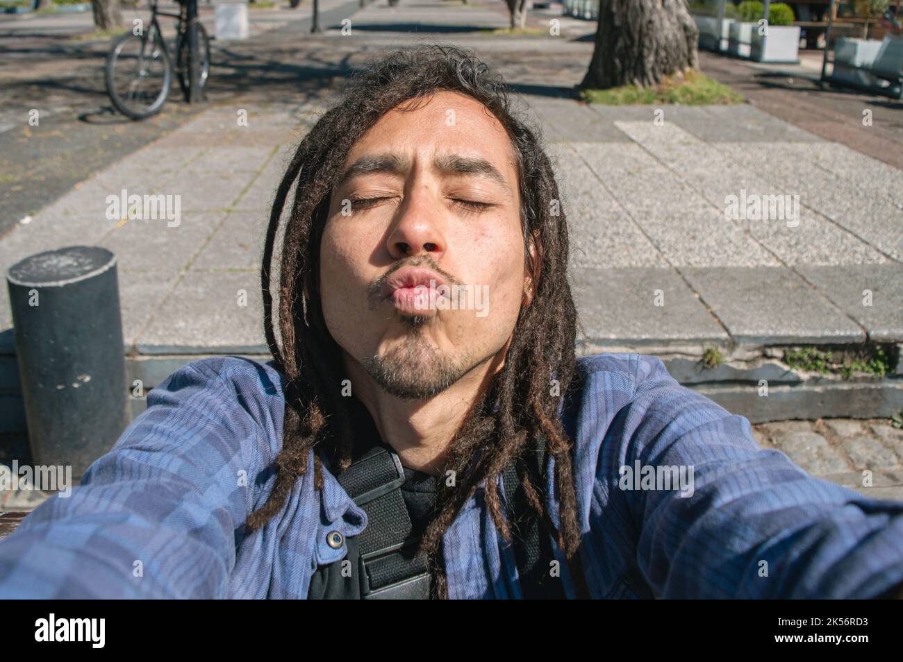 young latin venezuelan tourist man with dreadlocks and casual clothes ...