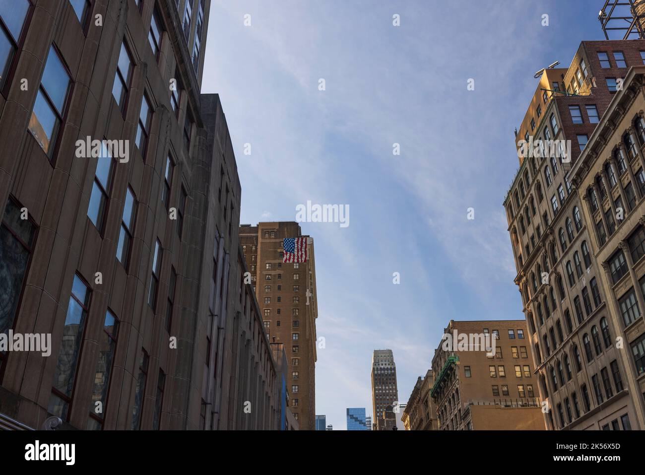 Beautiful bottom up view of blue sky between skyscrapers with USA flag ...