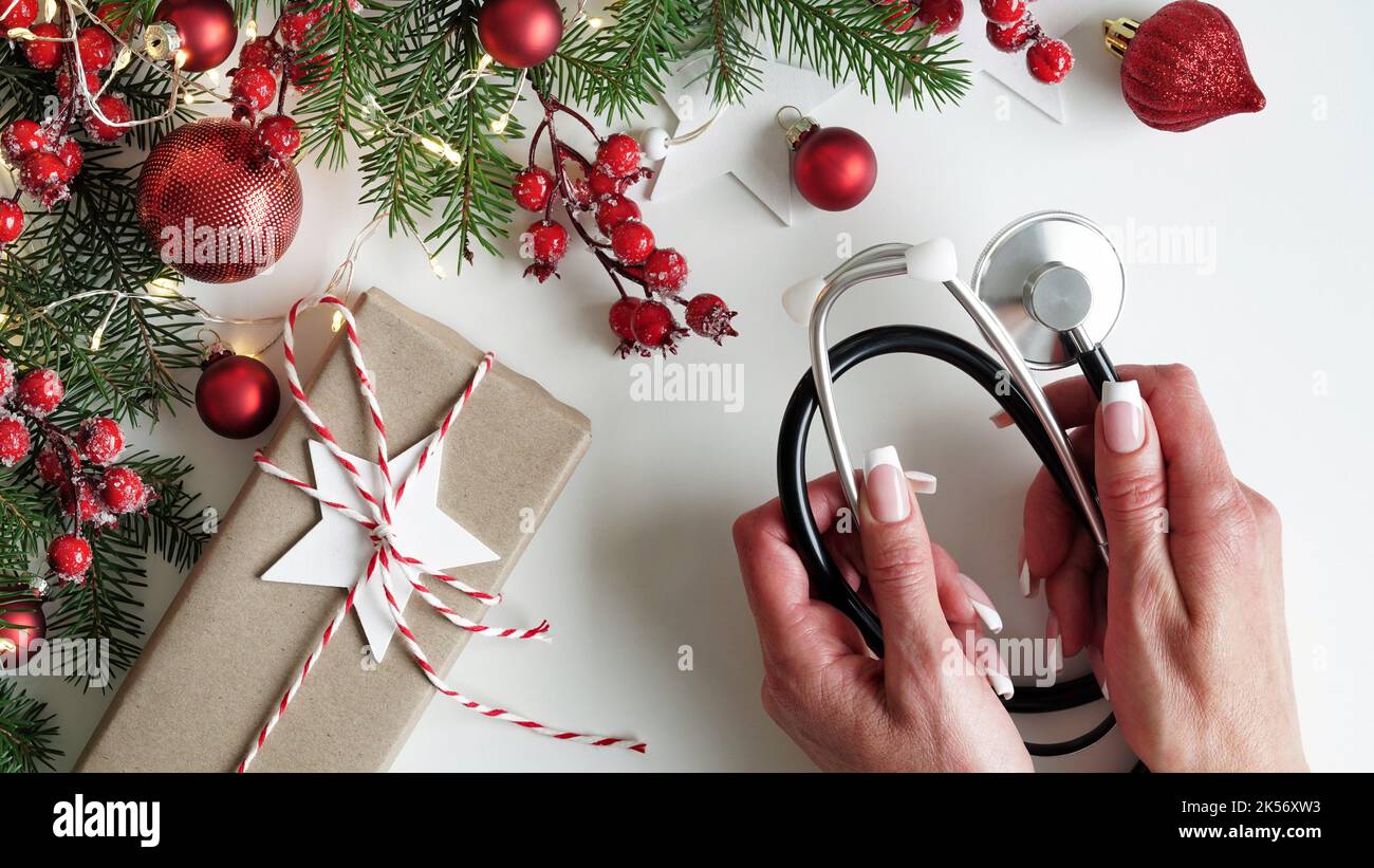 Christmas medical banner.Hands of woman doctor holding stethoscope on ...
