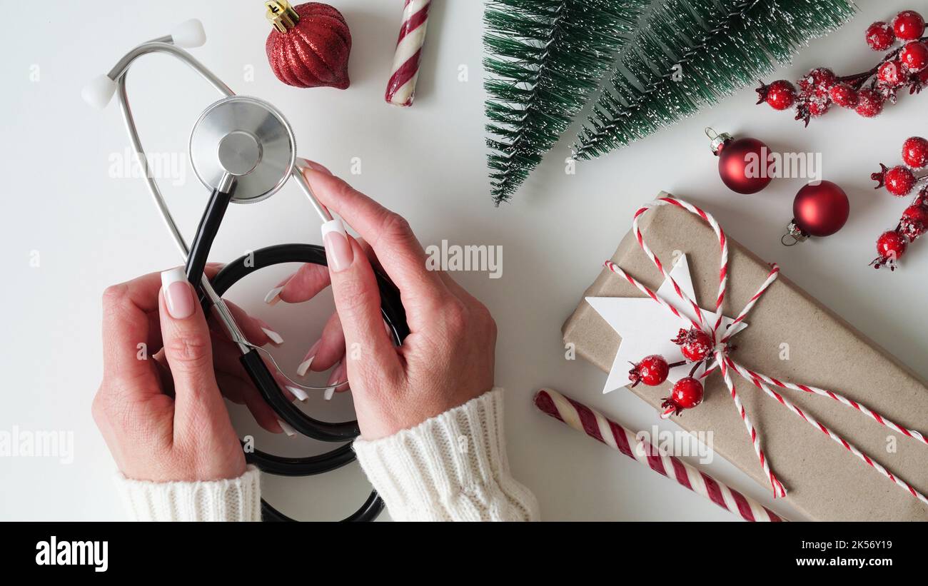 Christmas medical banner.Hands of woman doctor holding stethoscope on ...