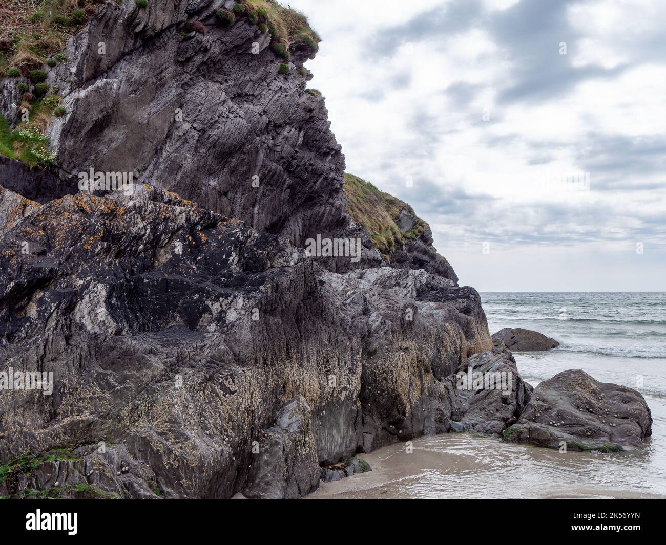 Sheer cliffs at Warren Beach. Beautiful sky. The picturesque coast ...