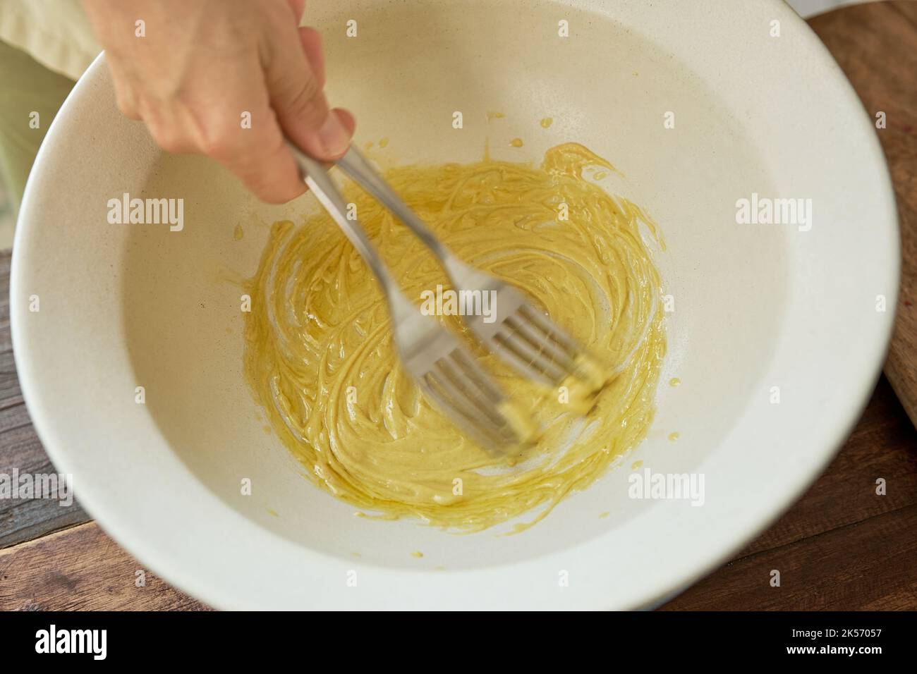 Crop woman with forks mixing mustard in bowl Stock Photo - Alamy