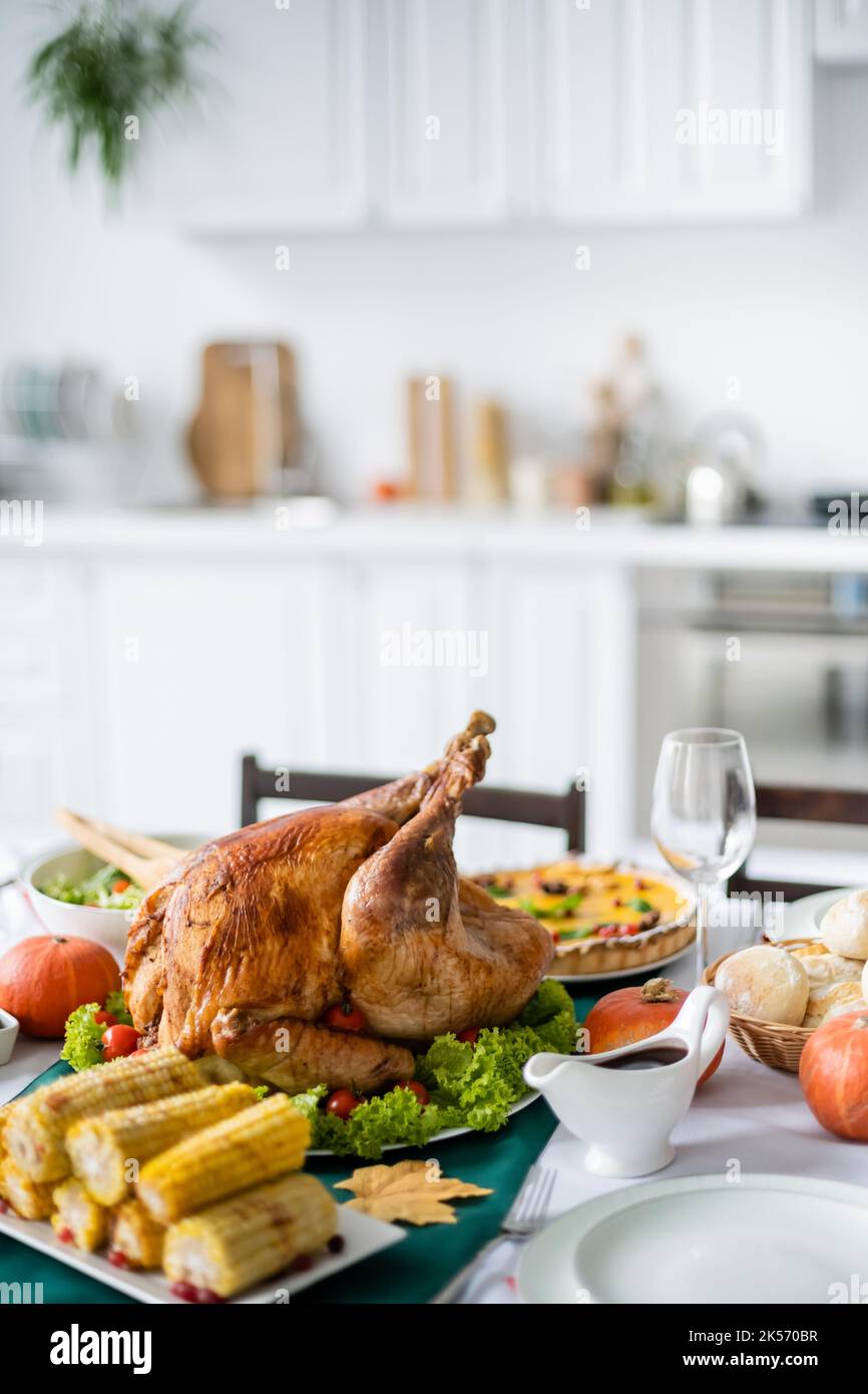 thanksgiving dinner with traditional roasted turkey and grilled corn in ...