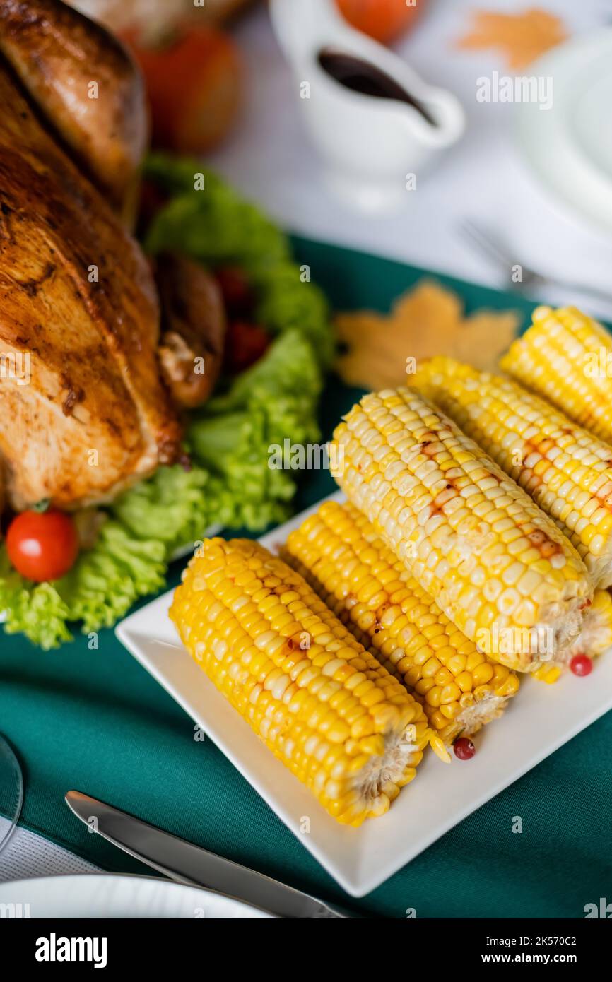 top view of grilled corn near delicious roasted turkey served for ...