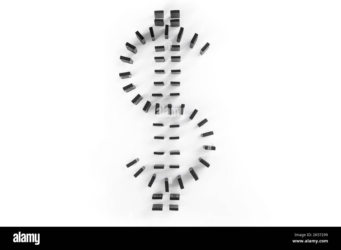 Black domino tiles arranged in the form of a dollar symbol, isolated on ...