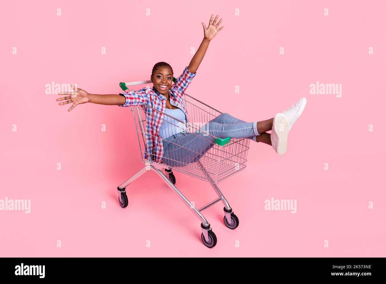 Full size portrait of overjoyed crazy lady sit shopping trolley raise ...