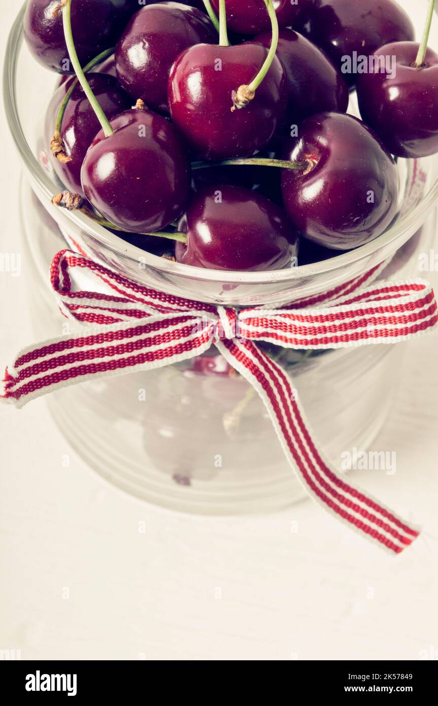 glass container with reed cherries Stock Photo - Alamy