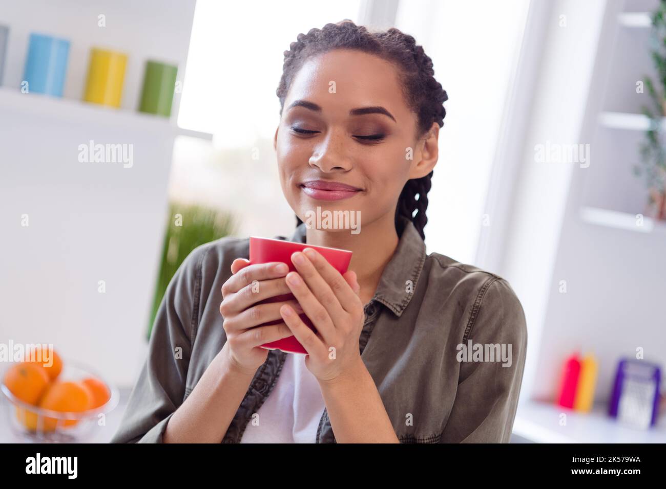 Photo of adorable pretty young female enjoying yummy scent from her cup smell delicious herbal ...