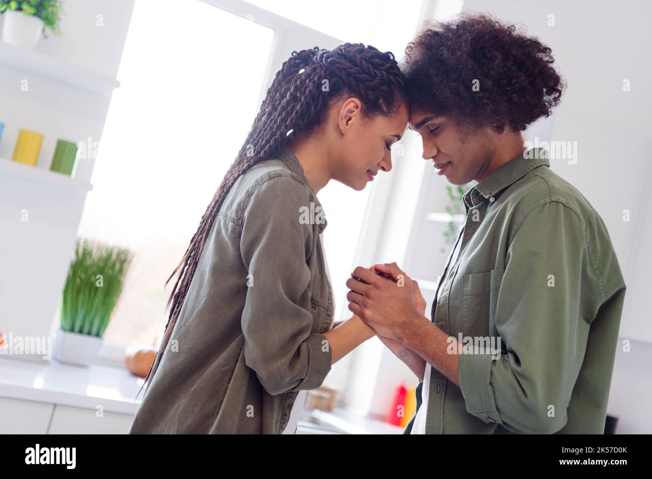 Photo of adorable couple touching foreheads touching hands express ...