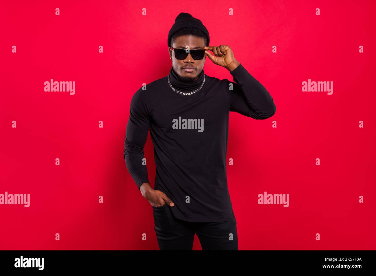 Portrait of attractive funky serious guy touching specs wearing black ...