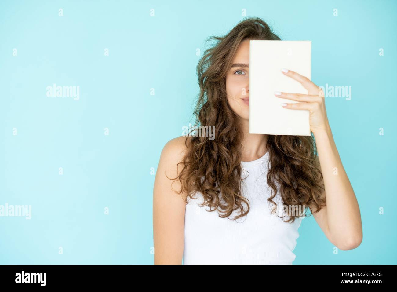 interesting book hiding woman curious mood Stock Photo - Alamy