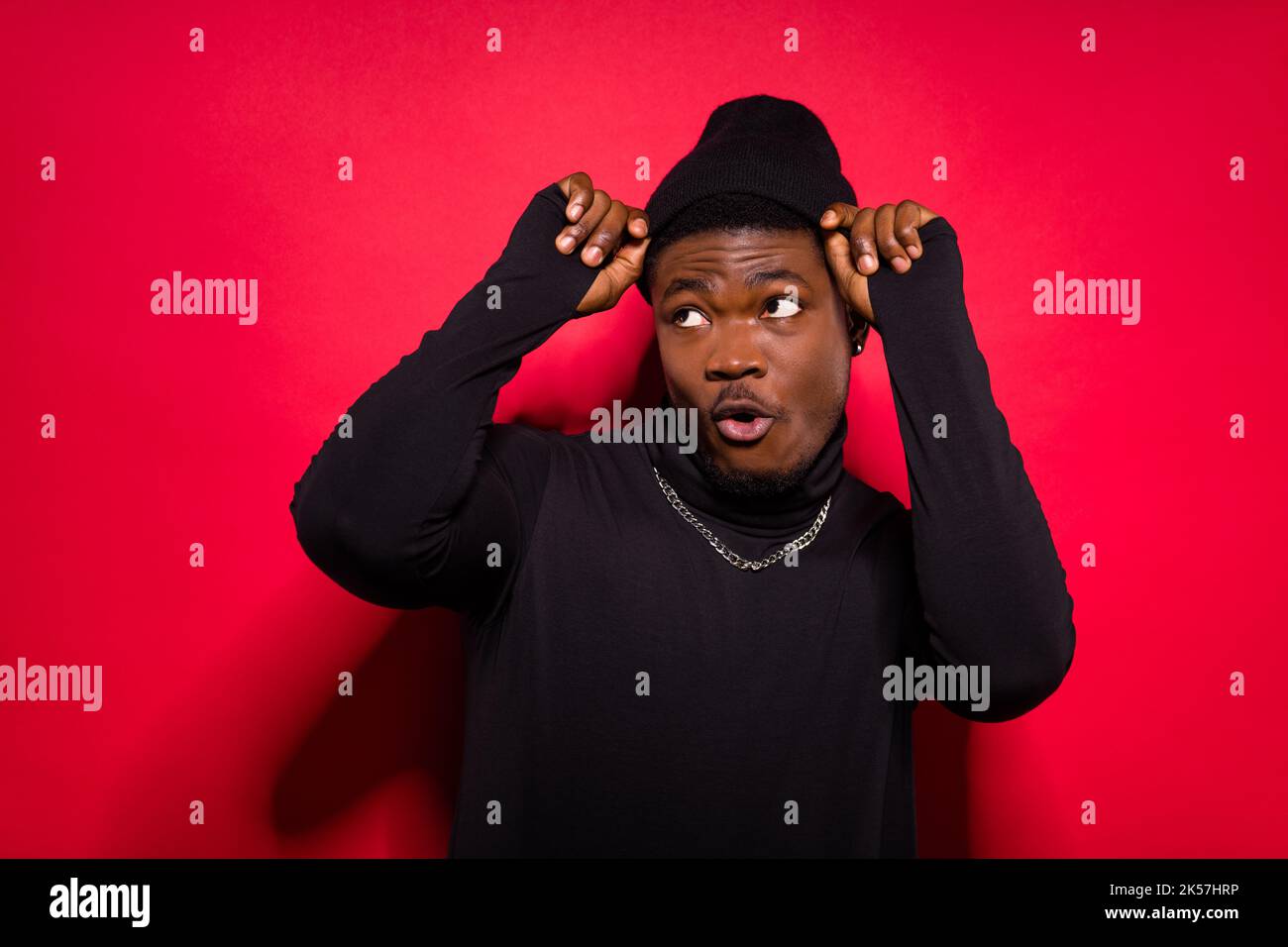Photo of funky impressed guy dressed black turtleneck adjusting ...