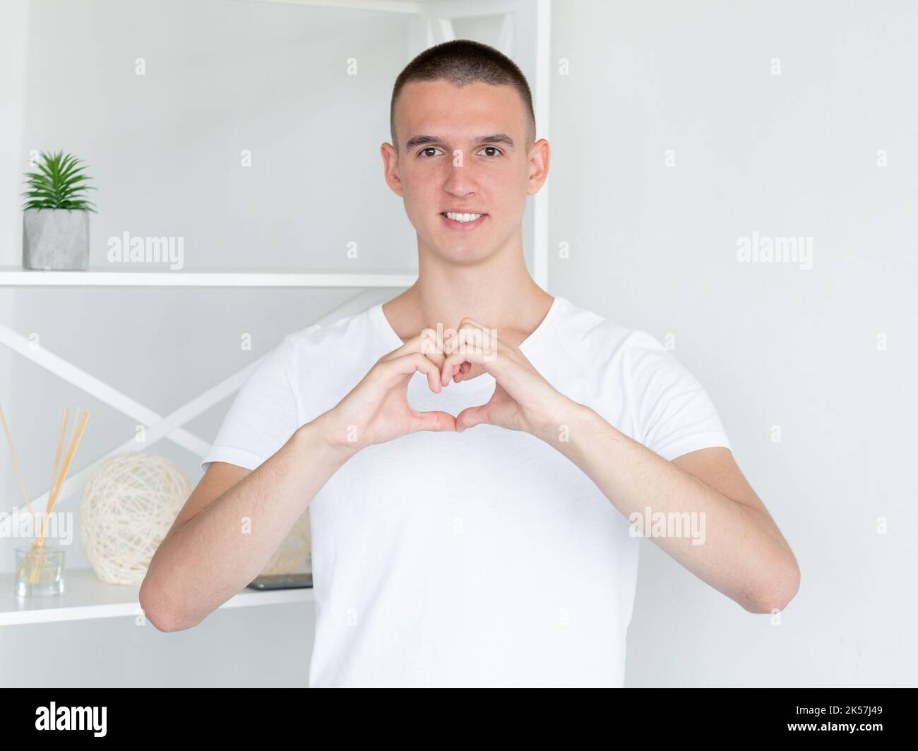 sending love smiling man positive emotion happy Stock Photo - Alamy