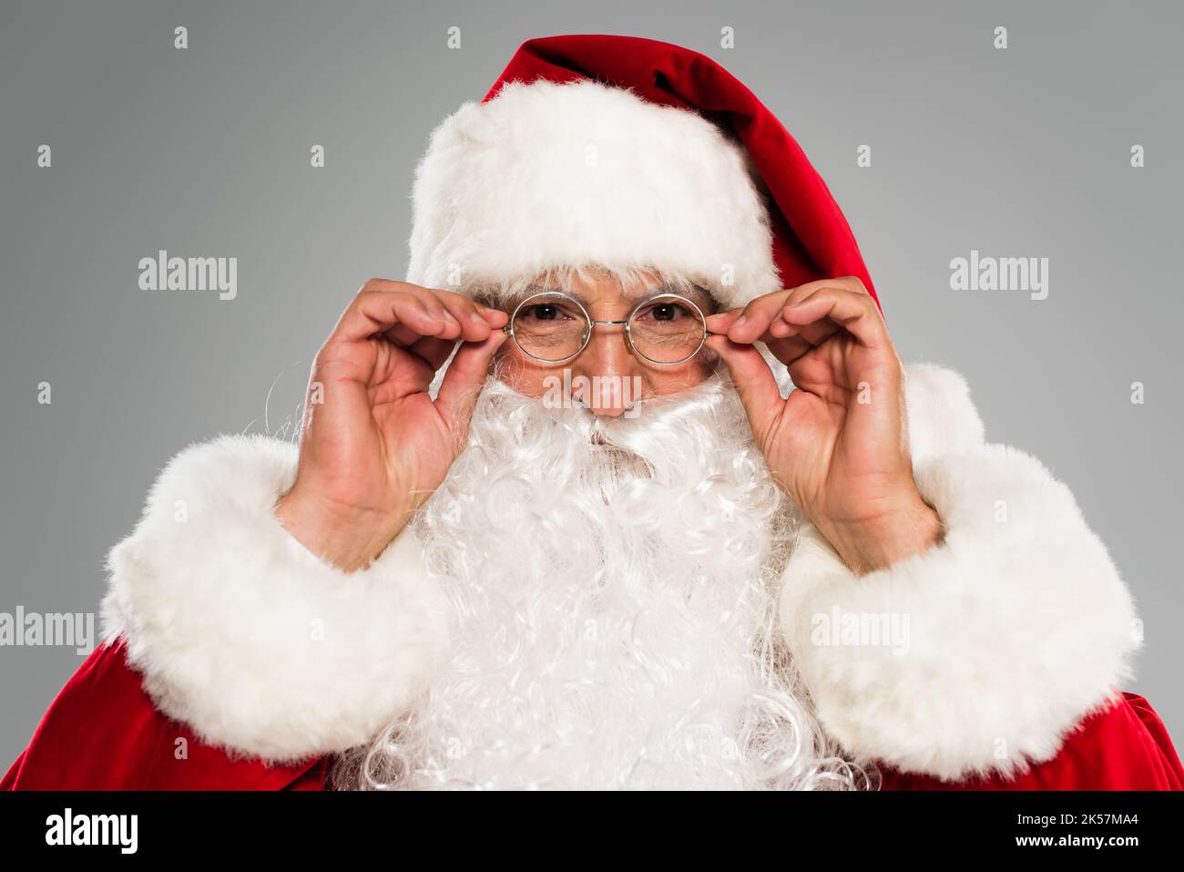 Portrait of santa claus wearing eyeglasses isolated on grey,stock image ...