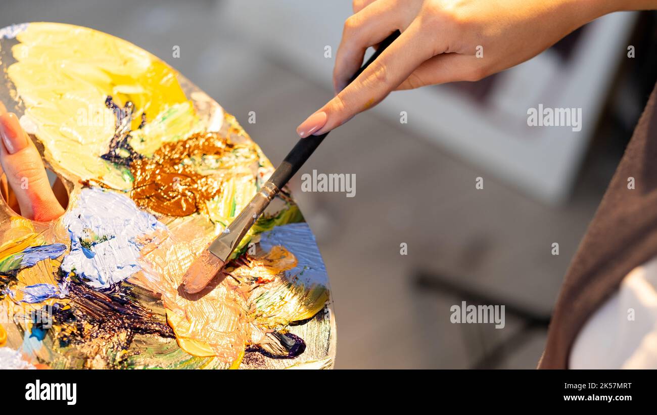 Painting process. Mixing colors. Fine art school. Unrecognizable woman ...