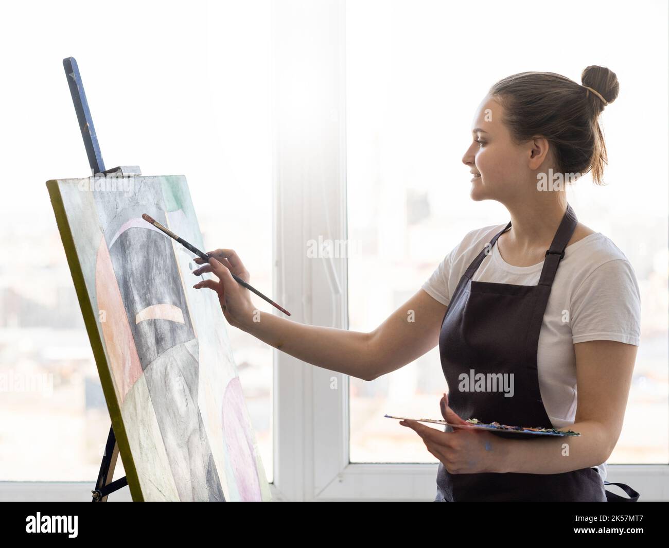 Art school. Female artist. Creative process. Enjoying study. Smiling ...