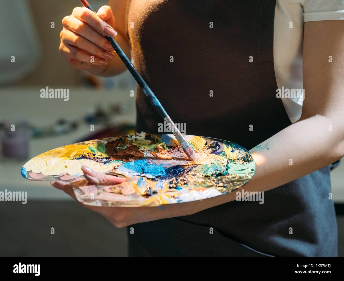 Mixing colors. Female artist. Creative process. Art tools ...