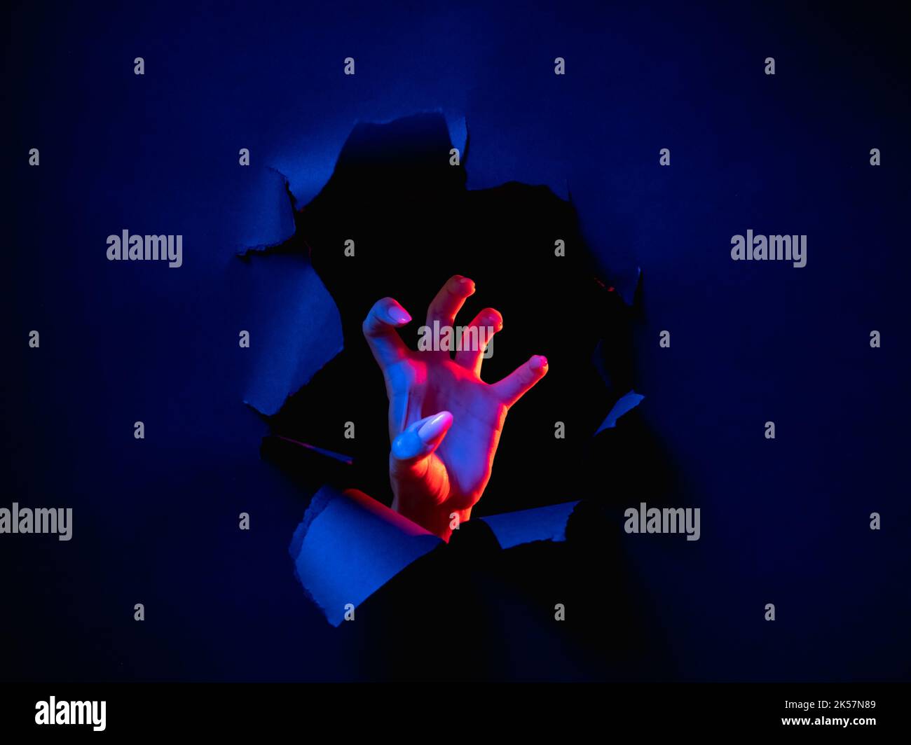scary gesture night horror hand breakthrough hole Stock Photo - Alamy