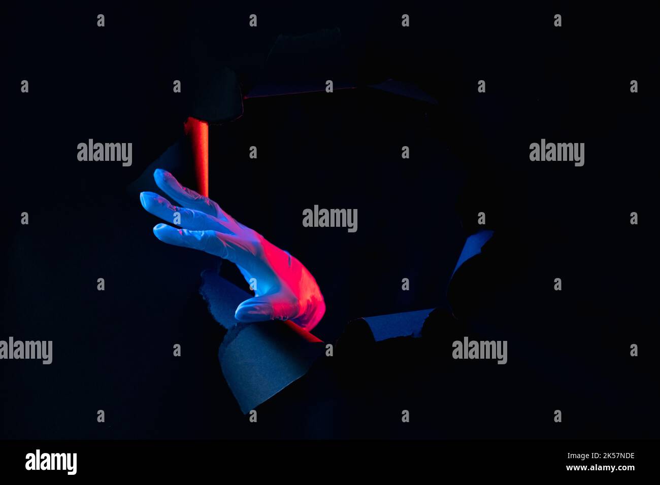 lab experiment hand breaking through torn wall Stock Photo - Alamy