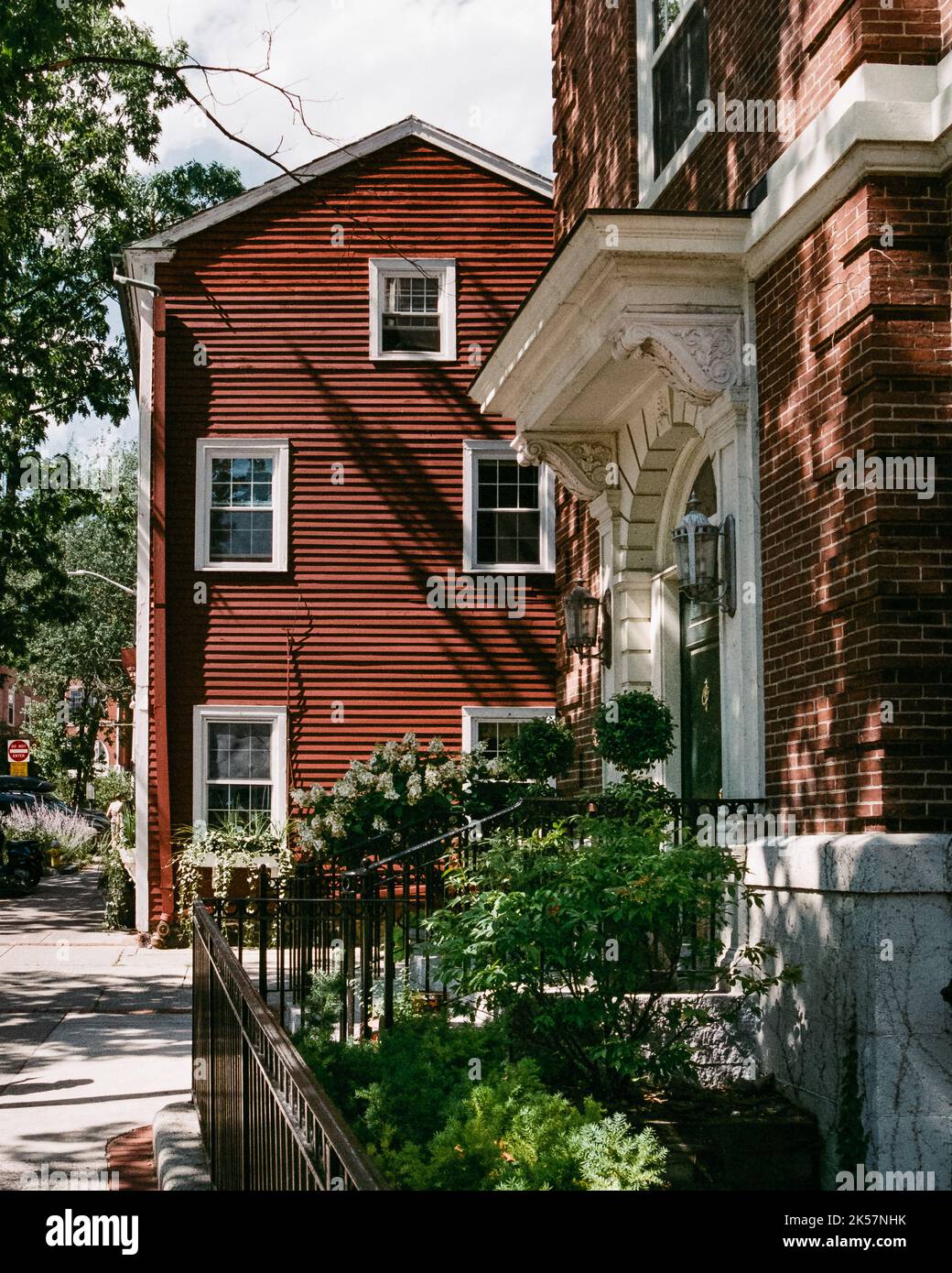 Picturesque street view of a blooming garden, classic brick building in ...