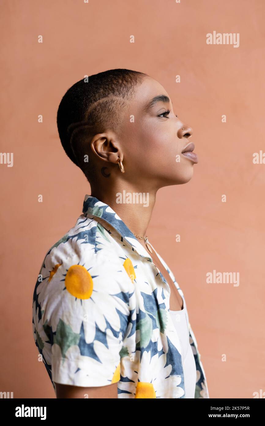 Side view of young short haired african american woman standing near ...