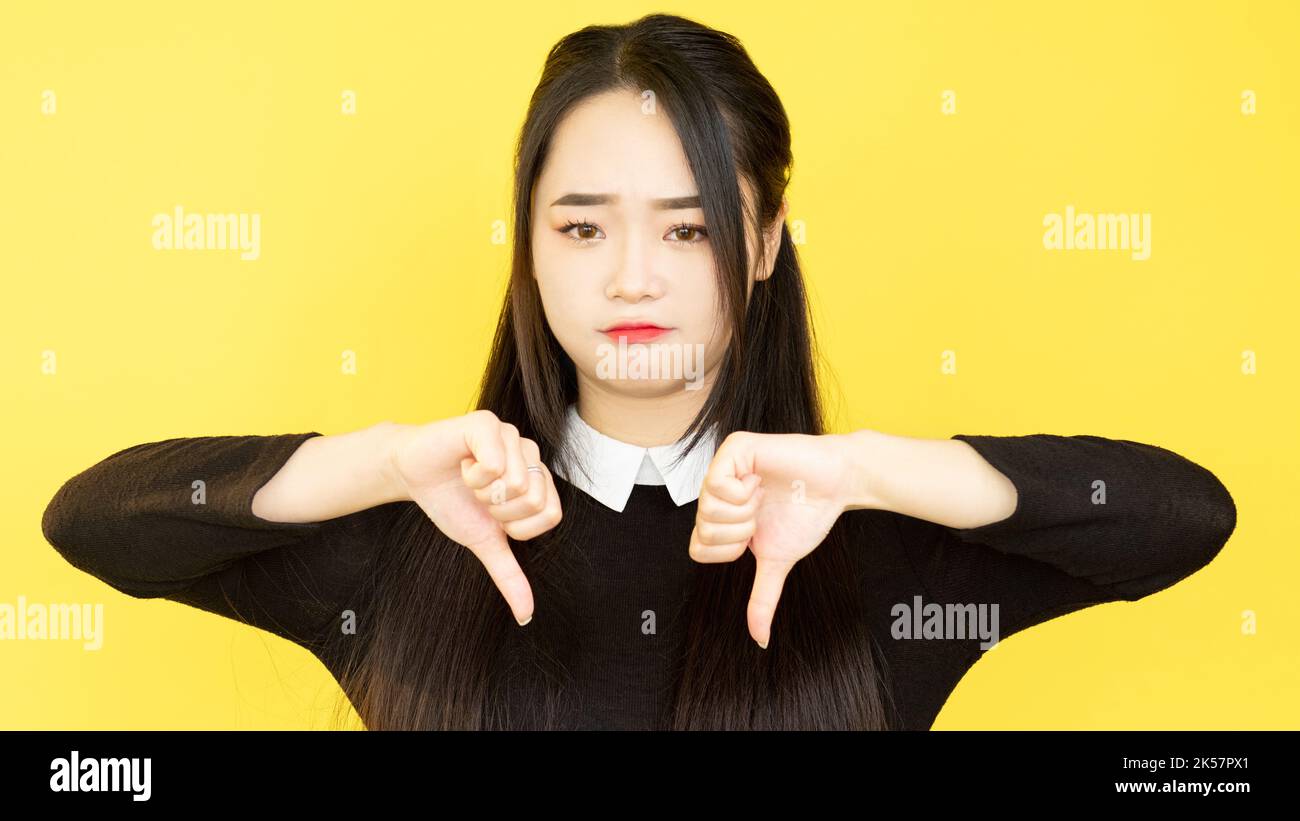 thumbs down gesture reject sign woman disapproval Stock Photo - Alamy