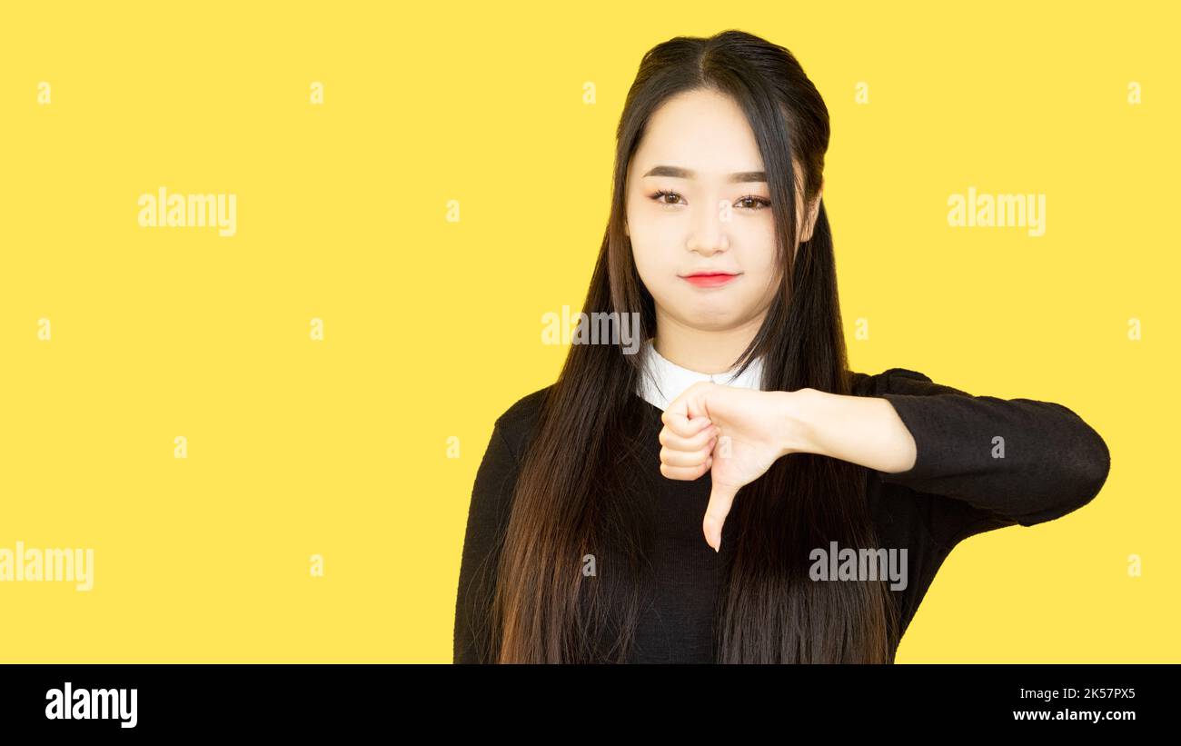 dislike gesture disapproval sign woman thumb down Stock Photo - Alamy