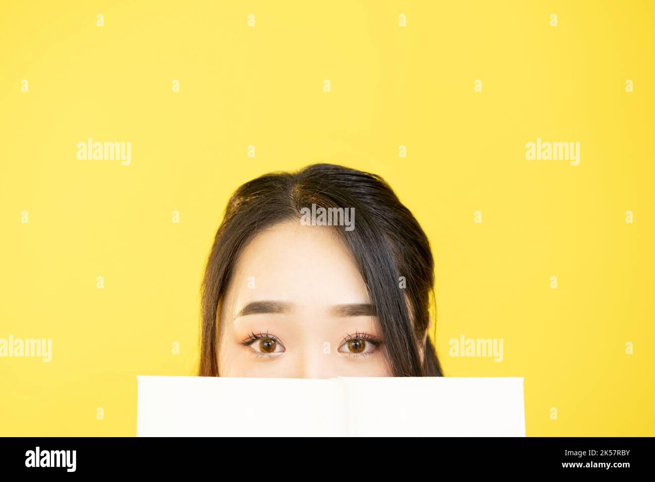 student portrait hiding woman school study book Stock Photo - Alamy
