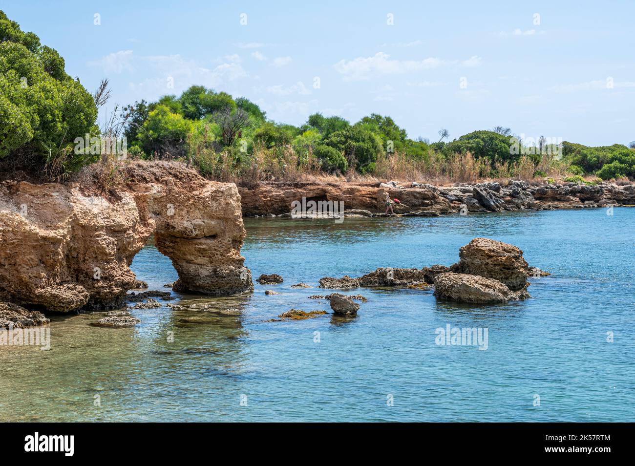 Beautiful beach with crystal clear water and a natural rock arch in ...